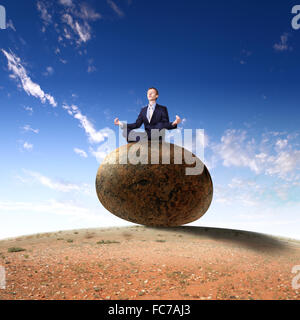 An image of a man rolling a rock uphill Stock Photo: 33940973 - Alamy
