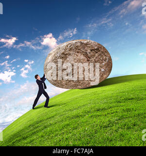 An image of a man rolling a rock uphill Stock Photo: 33940973 - Alamy