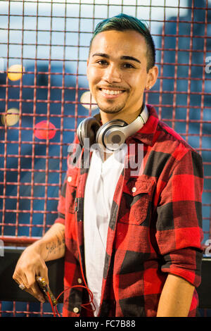 Hispanic transgender man wearing make up and pink wig scared and amazed ...