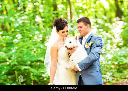 bride and groom with dog west highland white terrier Stock Photo - Alamy