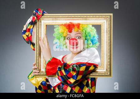 Clown with picture frame in funny concept Stock Photo - Alamy