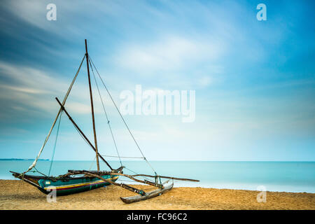 A traditional wooden oruwa fishing boat on shore in Bundala National ...