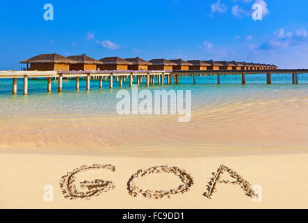 Text GOA on the sand on the beach on the background of blue sea and ...