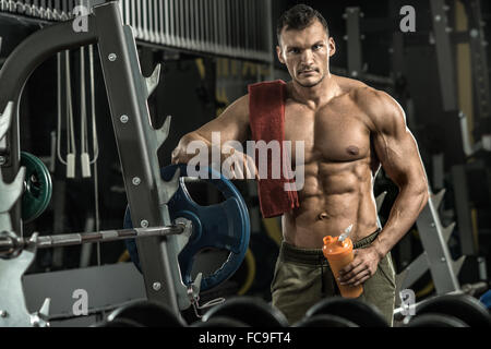 Photo of sportive bodybuilder man hold inflatable circle show biceps ...