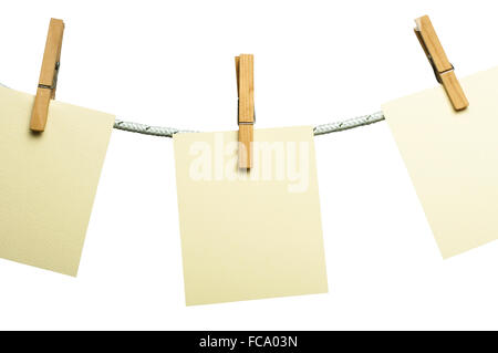 Note papers hooked on a rope. Sunset background Stock Photo - Alamy