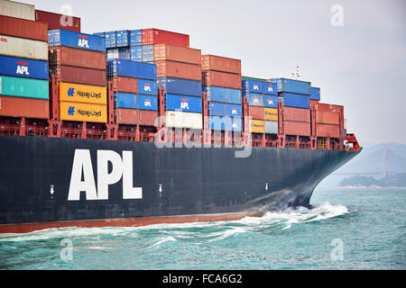 Fully laden container ship in port with its decks stacked with metal ...