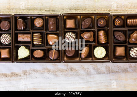 Assorted chocolates on wood table Stock Photo - Alamy