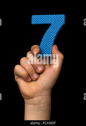Children hand holding the number Seven. White isolated multicolor ...