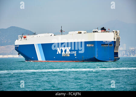 A container ship sails off a container terminal in Qingdao in east ...