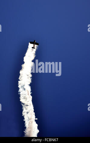 Acrobatic plane doing stunts and dropping smoke Stock Photo - Alamy
