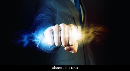 Businessman holding lightning in fist. Power and control Stock Photo ...