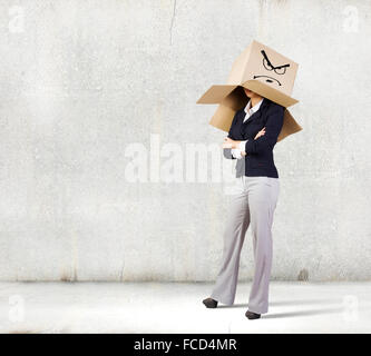 Businesswoman in suit wearing carton box on head Stock Photo - Alamy