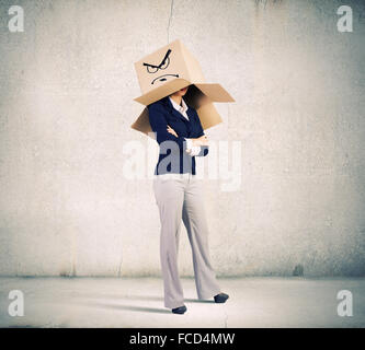 Businesswoman in suit wearing carton box on head Stock Photo - Alamy