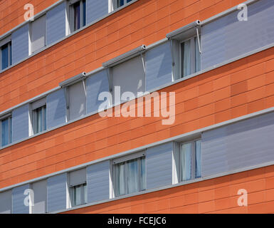 Modern building facade with metallic coating and trees. Horizontal ...