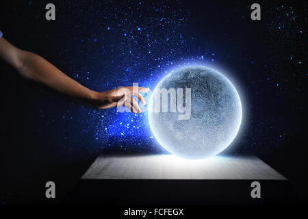 Close of man hands touching moon planet Stock Photo - Alamy