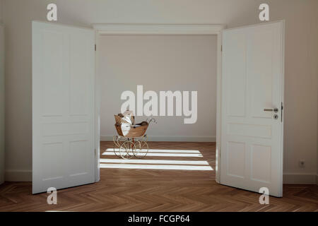 Pram in empty room open doors Stock Photo - Alamy
