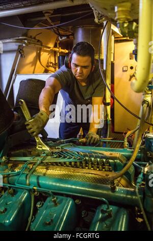 Boat mechanic repairing a ship engine Stock Photo - Alamy