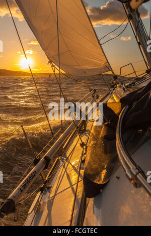 Sailing yacht boat heeled over on tack near entrance to harbour in ...