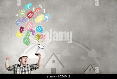 Young man engineer screaming emotionally in megaphone Stock Photo - Alamy