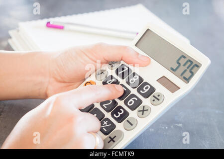 Hands holding and press calculator Stock Photo - Alamy