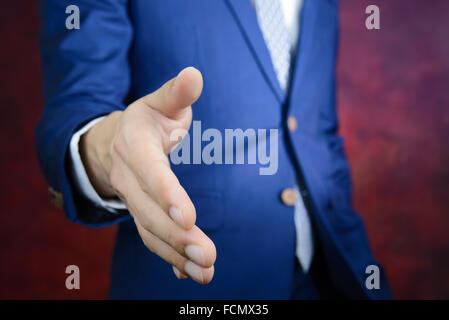 The hand of a man in a suit reaching from below into the frame Stock ...