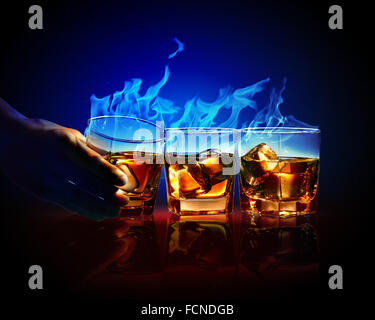 Three glasses of burning yellow absinthe Stock Photo - Alamy