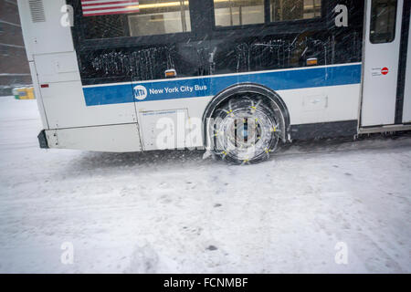 A New York City bus with chains on its tires for traction in the snow ...