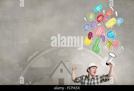 Young man engineer screaming emotionally in megaphone Stock Photo - Alamy