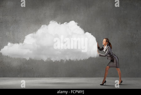 Attractive businesswoman pushing big cloud with effort Stock Photo - Alamy
