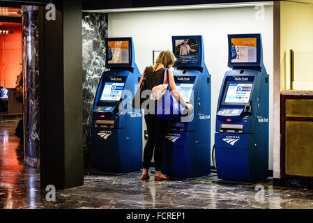An Amtrak Quik Trak ticketing kiosk and train departures board at ...