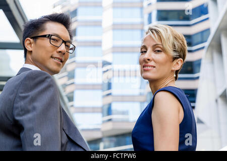 Businessteam members standing next to each other in business district ...