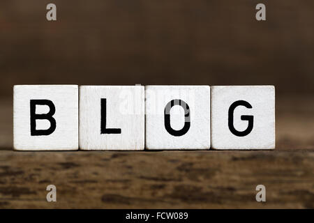 The word "blog" written in wooden letterpress type on a white washed ...