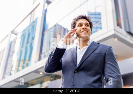 Portrait of confident businessman holding hs mobile phone outdoors Stock Photo - Alamy
