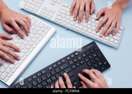 Hands typing on keyboards Stock Photo - Alamy