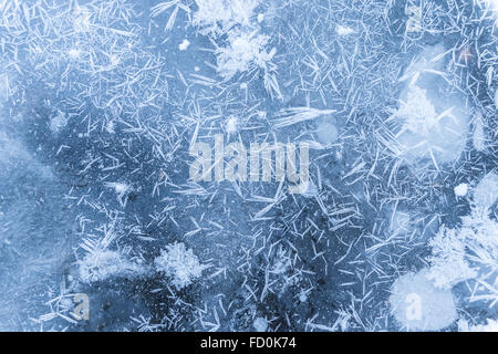 Ice crystals on the surface of a frozen glass during a cold winter day ...