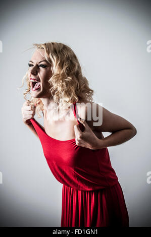 Angry woman screaming pulling her dress Stock Photo - Alamy