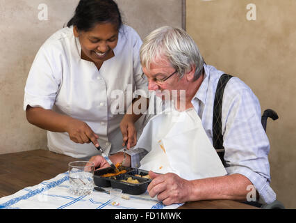 Grumpy old grandpa in nursing home receiving medication by a nurse ...