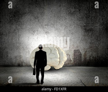 Rear view of businessman looking at big brain model Stock Photo - Alamy
