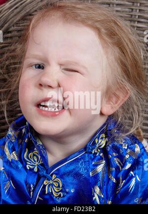 Little girl winking Stock Photo - Alamy
