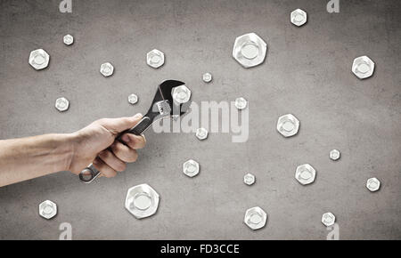 Close up of hand spinning nut with wrench Stock Photo - Alamy