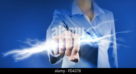 Image of powerful businesswoman holding lightning in fist Stock Photo ...