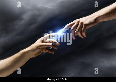 Michelangelo God's touch. Close up of human hands touching with fingers ...