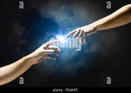 Michelangelo God's touch. Close up of human hands touching with fingers ...