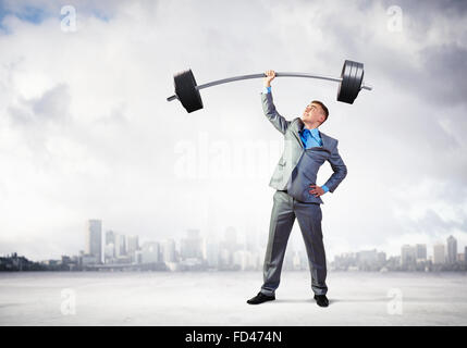 Confident businessman lifting above head barbell with light bulbs Stock ...