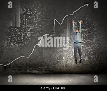 Image of jumping businessman trying to catch arrow of graph Stock Photo ...