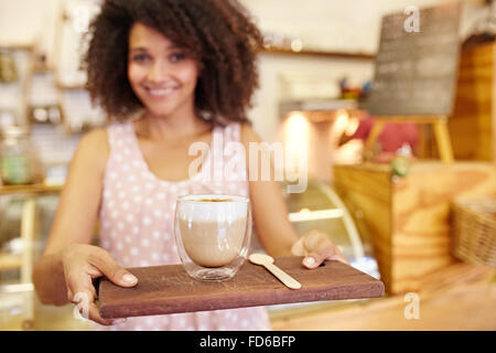 Young beautiful hispanic woman waitress smiling confident using ...