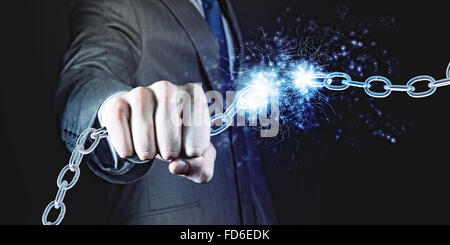 Powerful businessman holding chain in his fist Stock Photo - Alamy