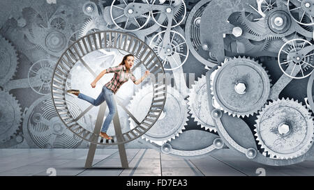 Young businesswoman running in wheel of gears mechanism Stock Photo - Alamy