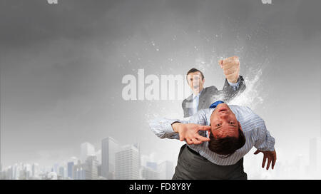 Two businesspeople in anger fighting with each other Stock Photo - Alamy