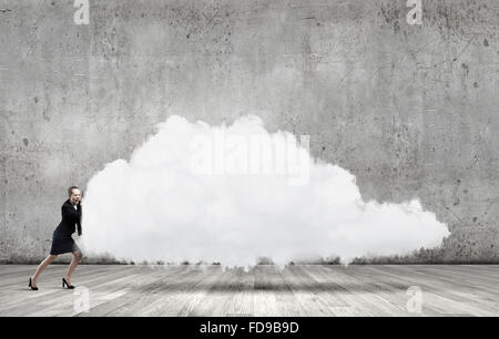 Attractive businesswoman pushing big cloud with effort Stock Photo - Alamy